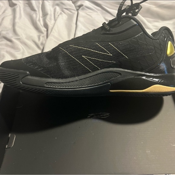 New Balance | Shoes | New Balance Black And Gold Athletic Shoes Sleek ...